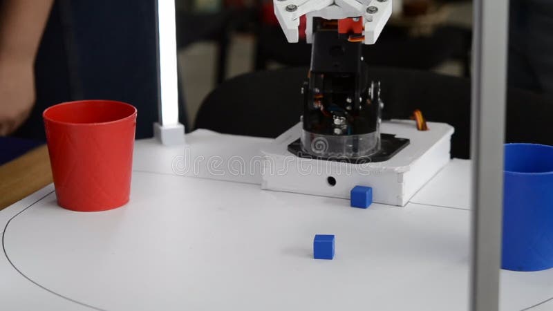 Robot Automatic Hand Taking Cubes and Putting in Glass. Automatic ...