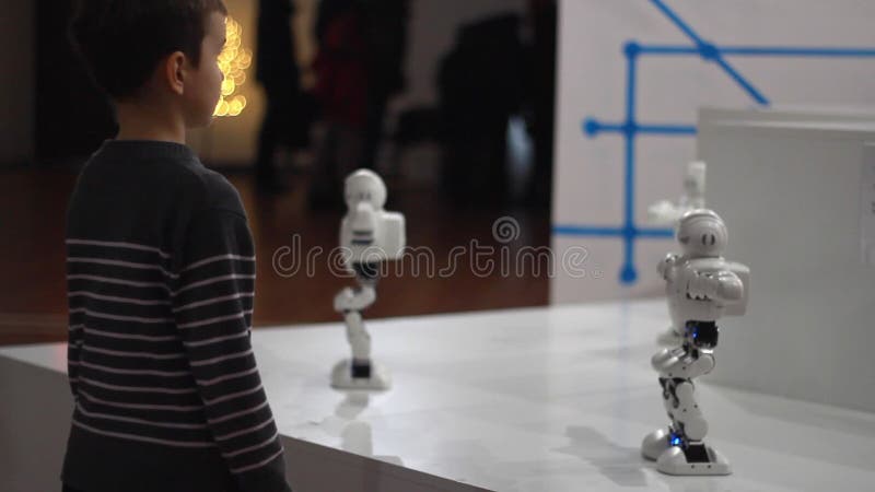 Robot and Child. Boy Looking for Dancing Robot. Boy and Group of Robot ...