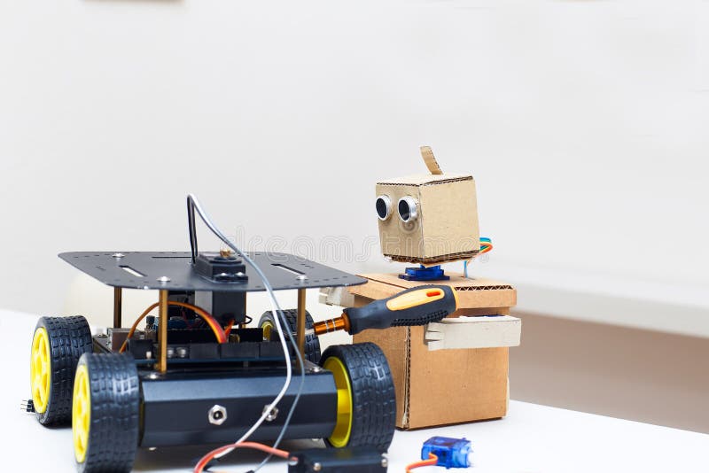 Robot with Hands Repairing Robot on Wheels Stock Photo - Image of ...