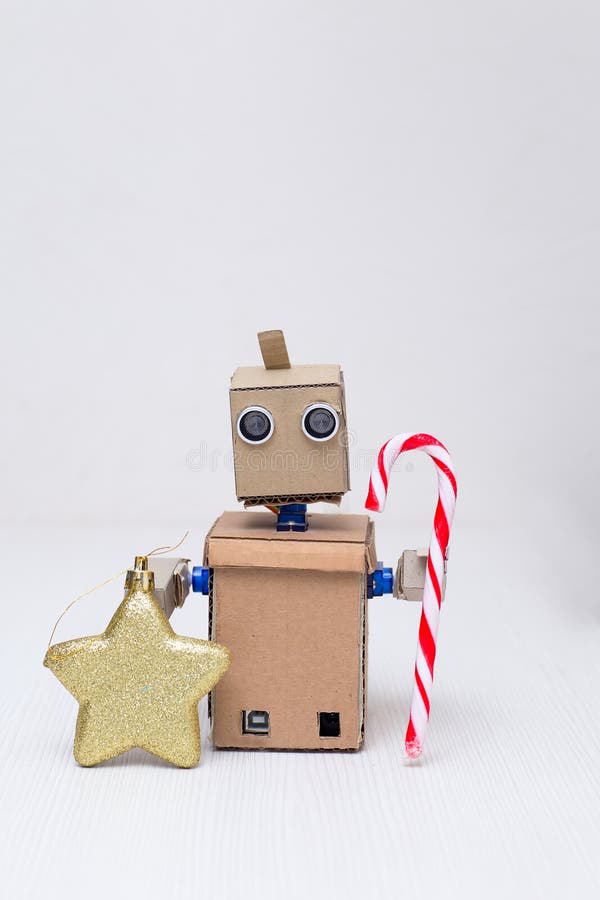 Robot Holding Christmas Decorations on the White Background Stock Photo ...