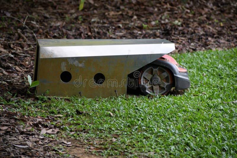 Robot Mower Inside Its Base To Recharge the Batteries. Stock Photo ...
