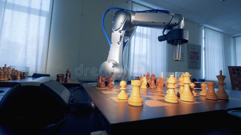 Robot Playing Chess with a Human. Computer Hand Manipulator Moves the ...