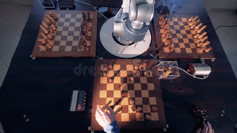 Robot Playing Chess with a Human. Computer Hand Manipulator Moves the ...