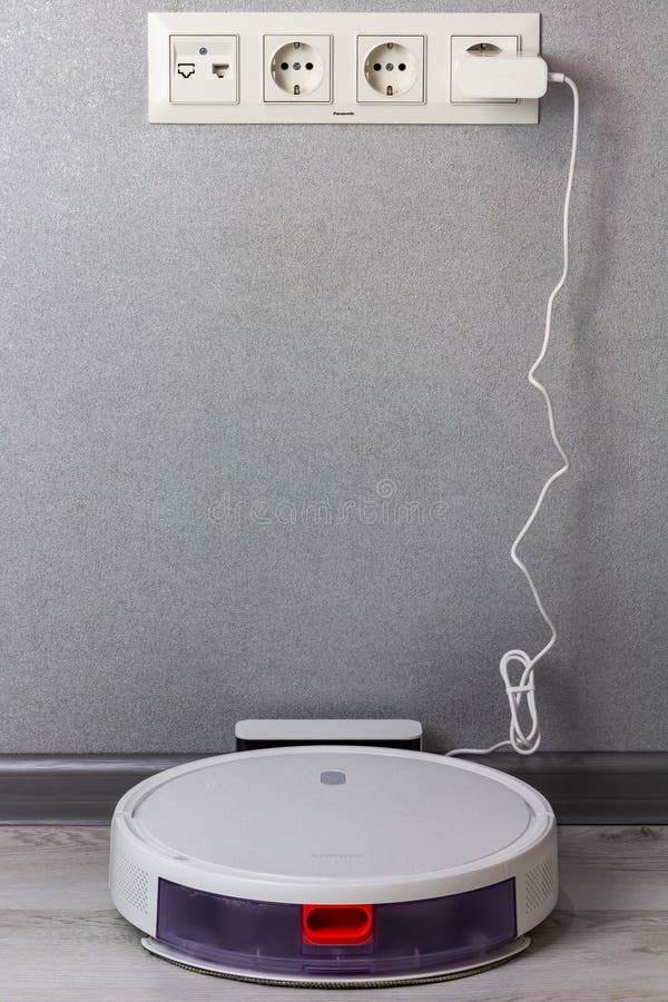 Robot Vacuum Cleaner on a Charging Station. Smart Technology Controlled ...