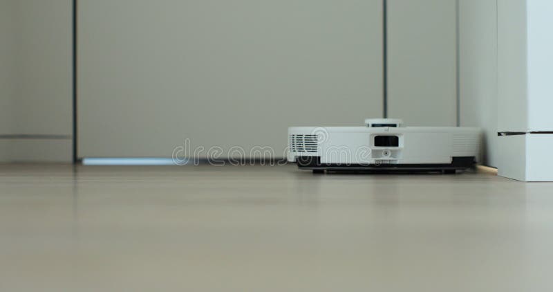 The Robot Vacuum Cleaner Cleans the Floor in the Room. Automatic House ...