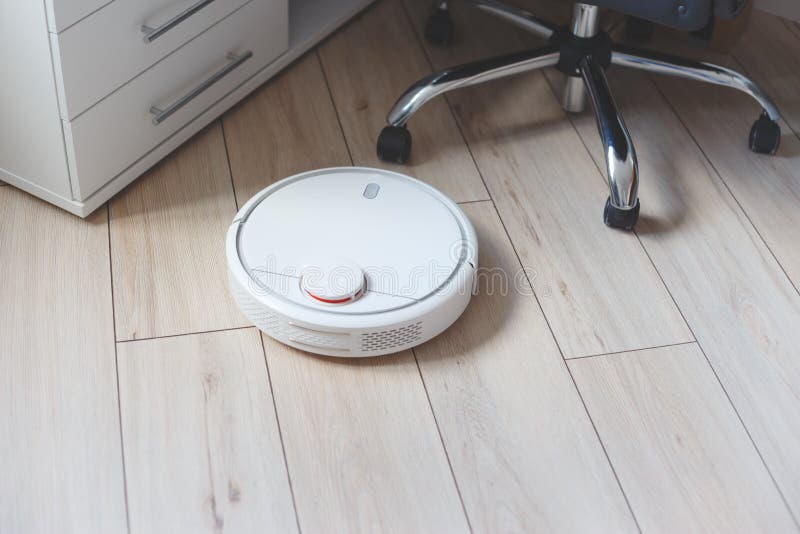 Robot Vacuum Cleaner Vacuuming Floor in Office Stock Image - Image of ...