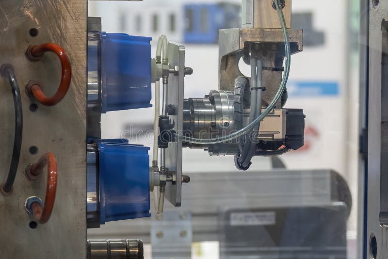 The Robotic Arm Gripping the Plastic Container Part at Injection ...