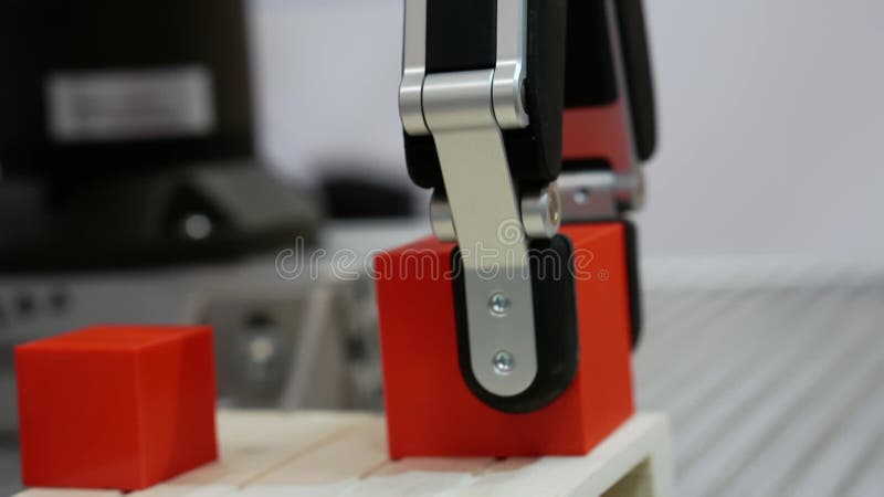 A Robotic Arm Moves a Cube-shaped Part. Stock Video - Video of robotics ...