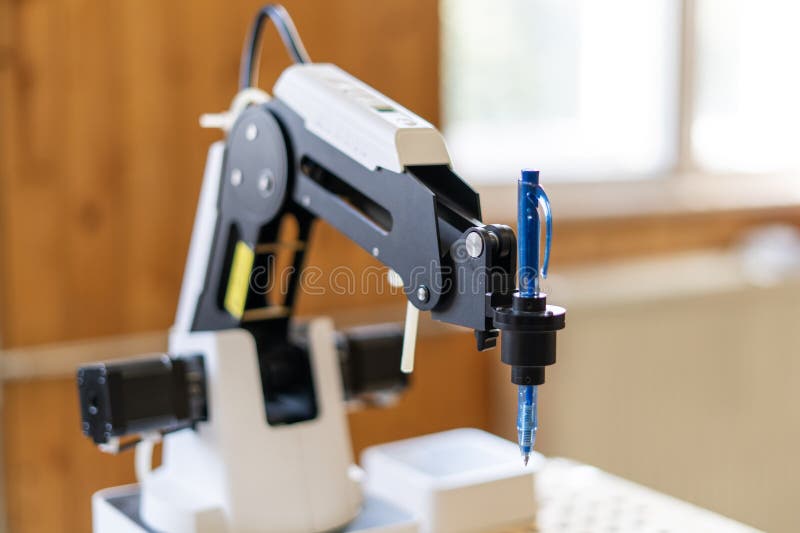 Robotic Arm Holding a Pen stock image. Image of education - 390643845