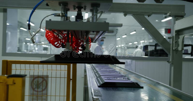 A Robotic Arm Stacks Computer Monitors on a Conveyor Belt. a Large ...