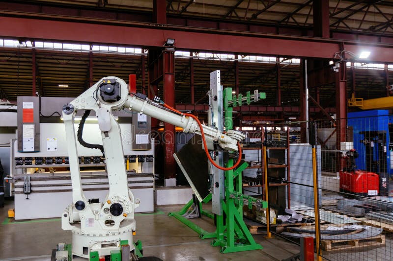 Robotic Arm Working with Metal Sheet at Metalworking Factory Stock ...
