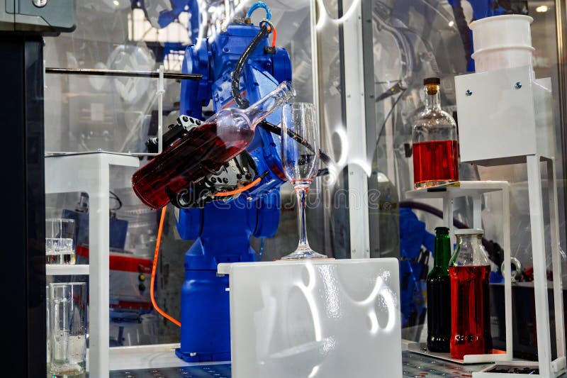Robotic Bartender Arm Pouring a Cocktail into a Glass in a Bar Setting ...