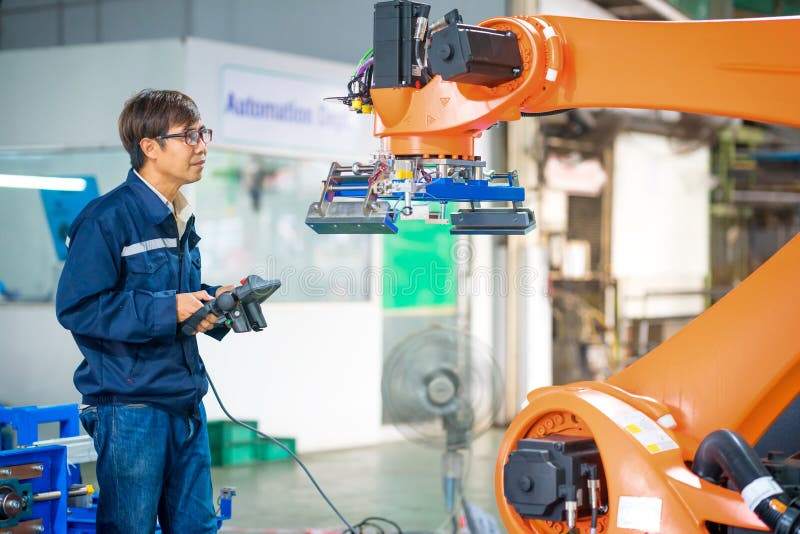 Robotic Engineer is Setting Handling Robot during Installation ...
