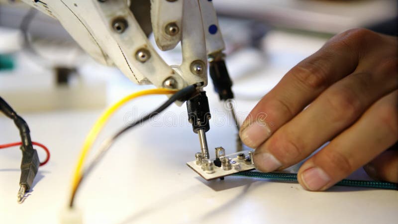 A Robotic Hand Equipped with Intricate Tools Meticulously Aligns and ...