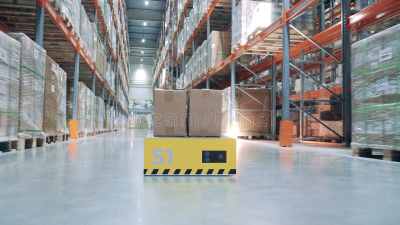 Robotic Machine is Transporting a Box through the Warehouse Stock ...