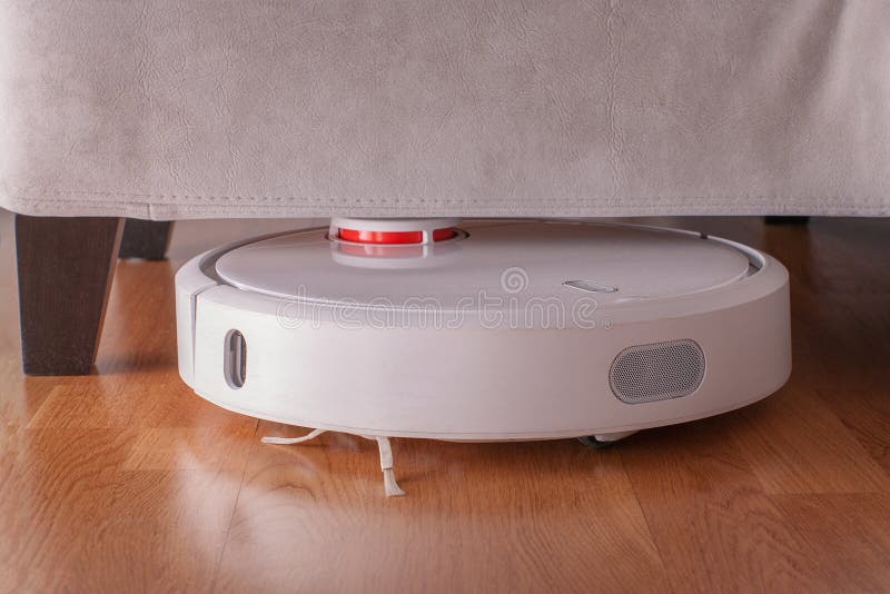 Robotic Vacuum Cleaner Runs Under Sofa In Room On Laminate Floor Robot Controlled By Voice
