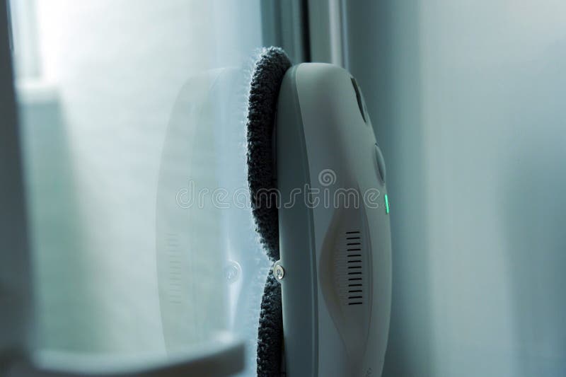 Robotic Window Cleaner Diligently Cleans a Window Pane, Showcasing Its ...