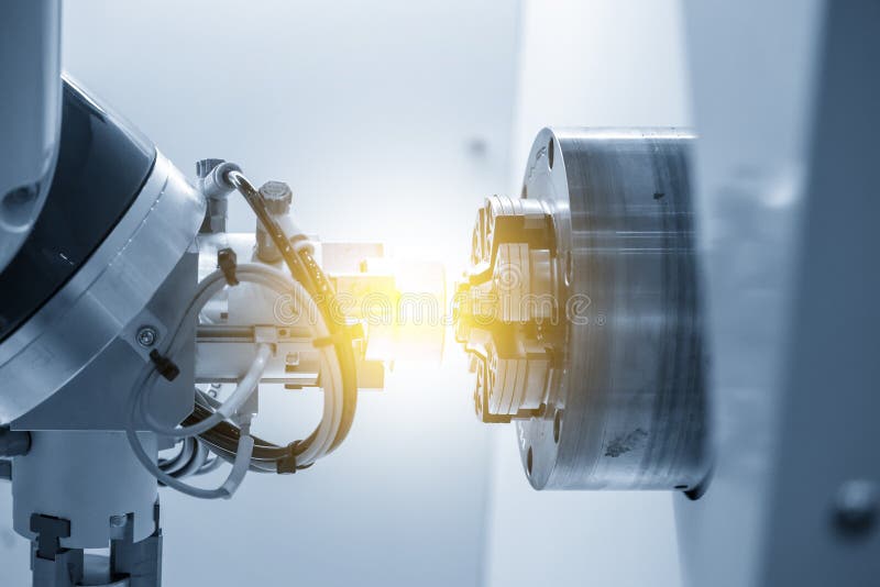 The Robotics Arm Gripping the Metal Part from CNC Lathe Machine with ...