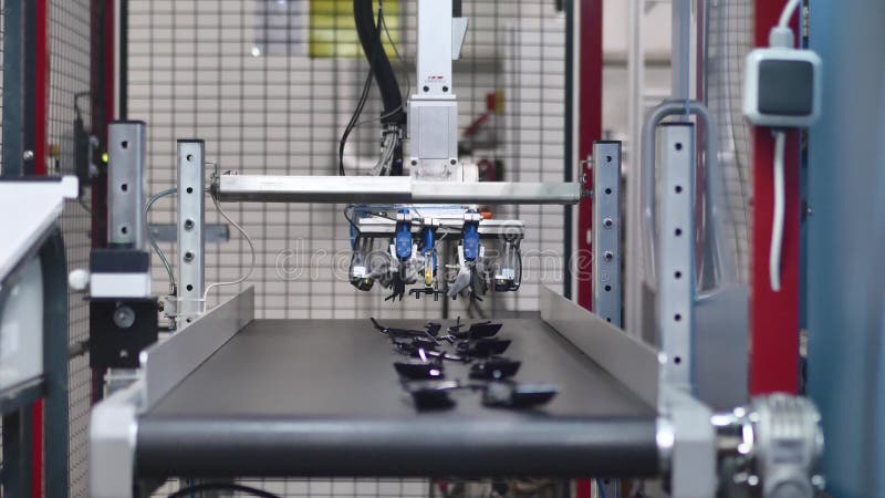 Robotics Arm Inserts Plastic Component on the Belt from the Injection ...