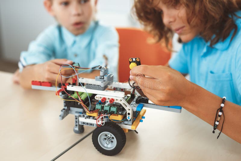 Robotics. Children Sitting Having Class Working on Robots Using Laptop ...