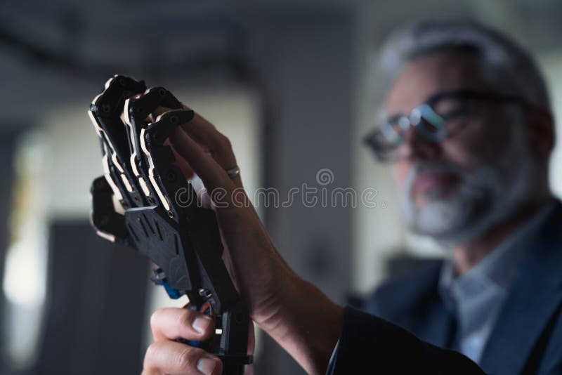 Robotics Engineer Adjusting, Calibring Robotic Prosthetic Hand. Concept ...