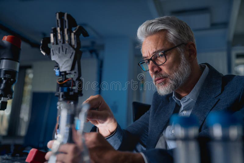 Robotics Engineer Adjusting, Calibring Robotic Prosthetic Hand. Concept ...