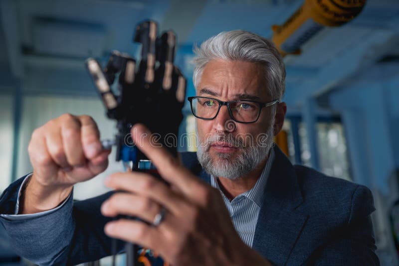 Robotics Engineer Adjusting, Calibring Robotic Prosthetic Hand. Concept ...