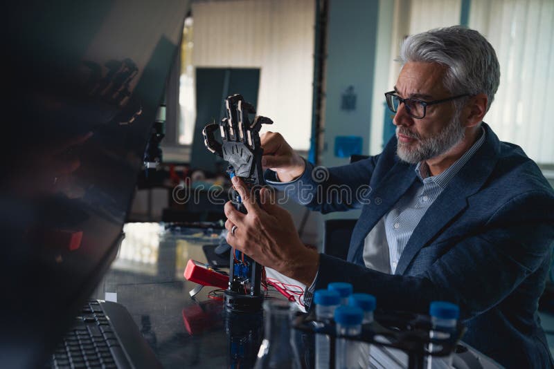 Robotics Engineer Adjusting, Calibring Robotic Prosthetic Hand. Concept ...