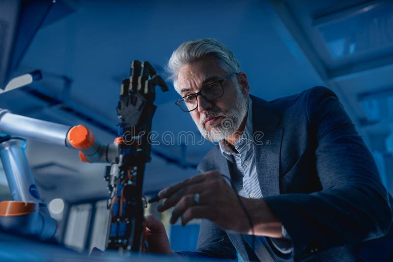 Robotics Engineer Adjusting, Calibring Robotic Prosthetic Hand. Concept ...