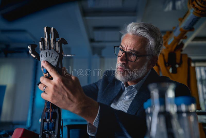 Robotics Engineer Adjusting, Calibring Robotic Prosthetic Hand. Concept ...