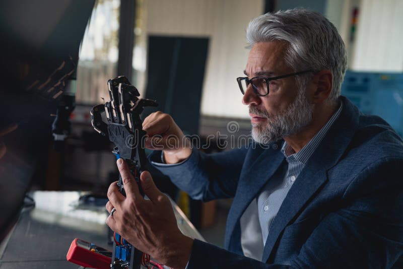 Robotics Engineer Adjusting, Calibring Robotic Prosthetic Hand. Concept ...