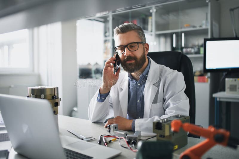 Robotics Engineer Working on Desing of Modern Robotic Arm in Laboratory ...