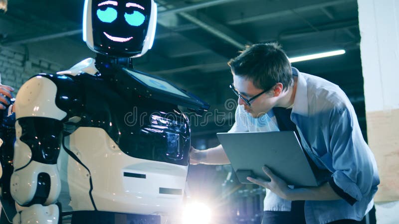 Robotics Engineers are Observing a Robotic Arm in Modern Lab Stock ...