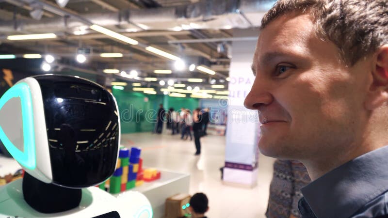 Robotics Technology. Guy Talk with Robot. Robot Head with Camera Scan ...