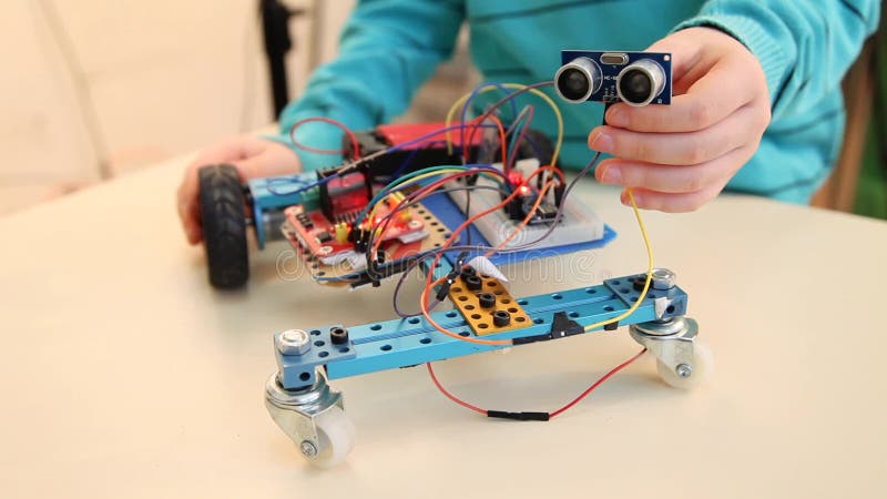 STEM Concept: Boy Adjusts His Robot. Programs for Learning Coding Study ...