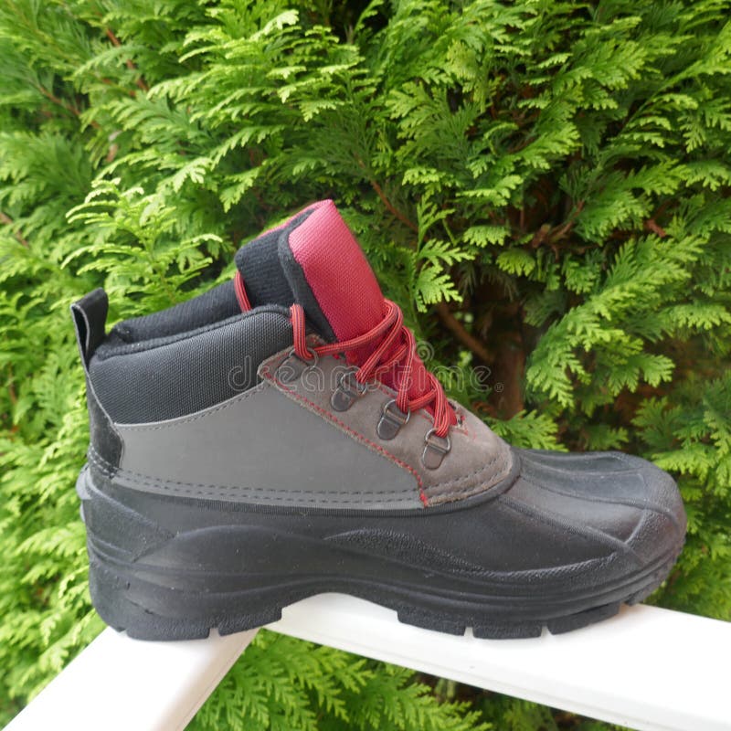 Robust, Waterproof Outdoor Boot for Men, Side View, in Front of a Green ...