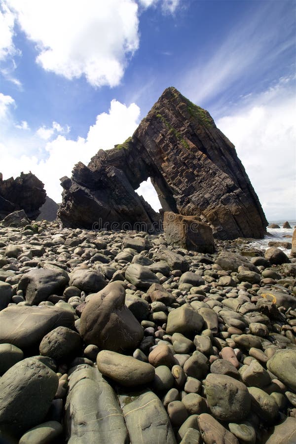 A rock arch on a beach stock image. Image of rock, erosion - 106814507