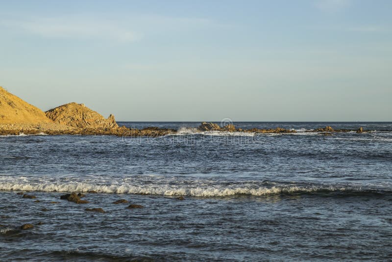 Rock barrier on beach stock image. Image of boulders - 58346683
