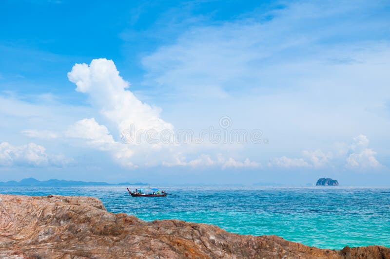Rock Beach with Crystal Clear Water and Boat Stock Photo - Image of ...