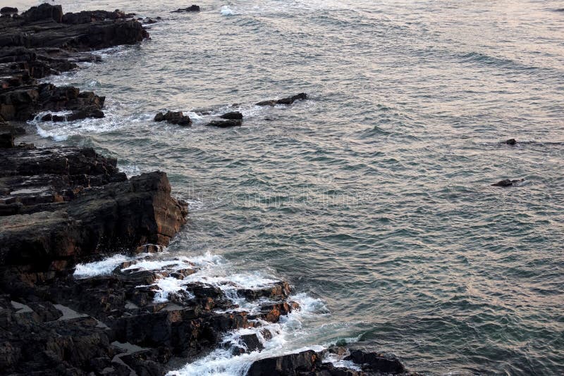 Rock beach in goa stock photo. Image of evening, ocean - 106764816