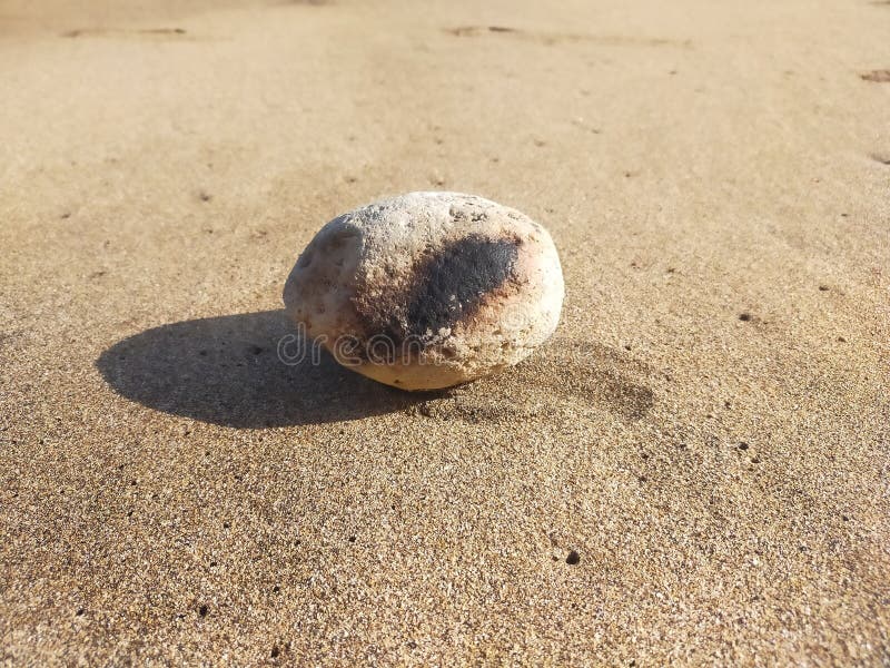 A Rock on the Beach Sand with Sunlight Shadow Stock Image - Image of ...
