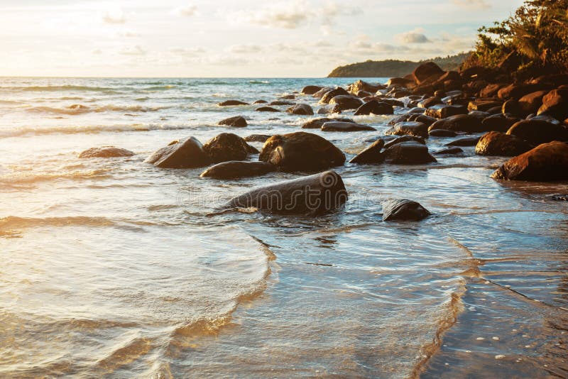 Rock on beach with sunset stock photo. Image of asia - 137811754