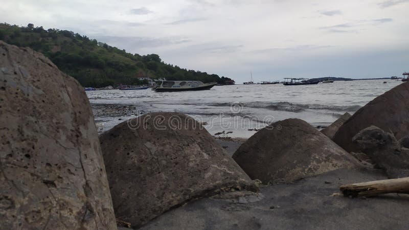 Rock and Boat in Beach Photo Stock Image - Image of boat, geology ...
