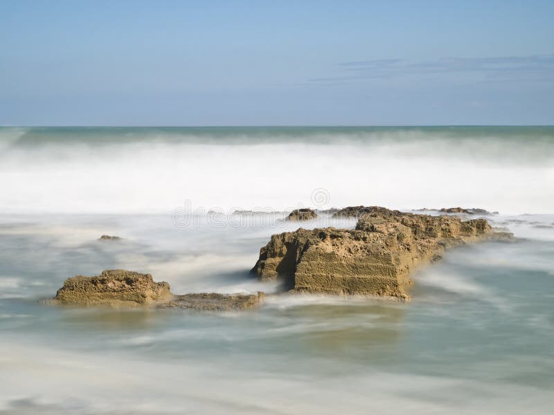Rock in a Brave Sea stock photo. Image of splash, flow - 13363998