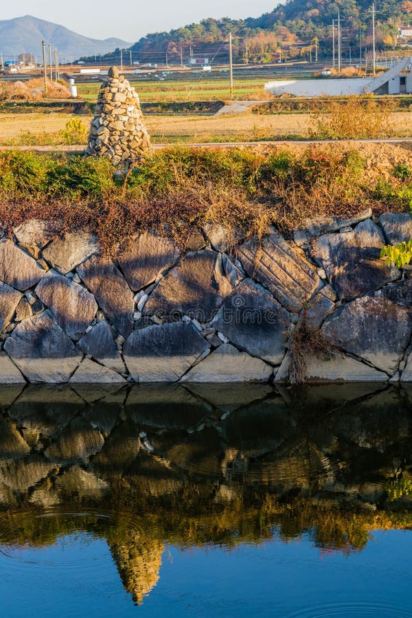 Rock Cairn Reflected in Blue Water Stock Image - Image of canal, iksan ...