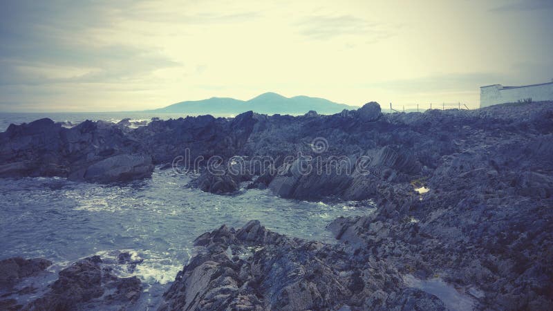 Rock stock image. Image of sharp, calm, water, rock, bellow - 76156743