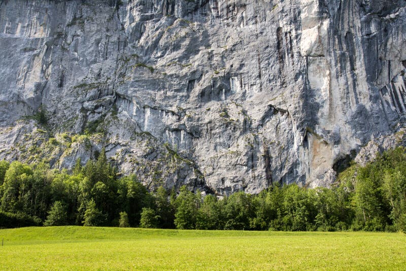 Rock cliff in Alps stock image. Image of geological, grass - 97737345