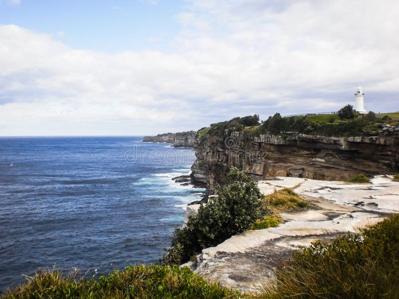 Rock Cliff with Lighthouse beside the Sea Stock Photo - Image of ...