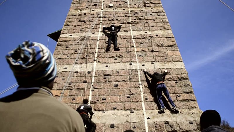 Rock Climber Woman Climbing Up a Sheer Cliff in Mountain Gear. a Rock ...