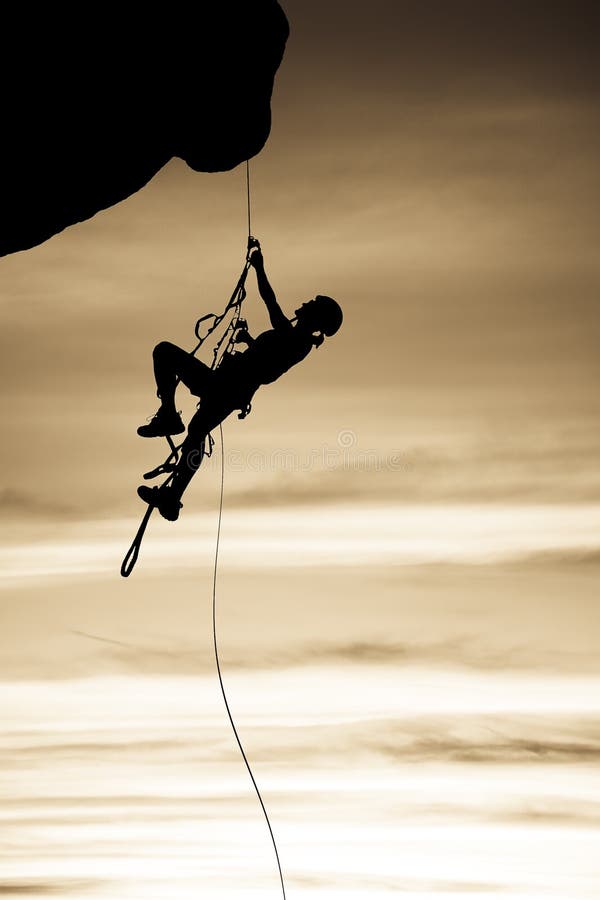 Rock Climber Dangling From A Rope. Stock Photo - Image of airborne ...